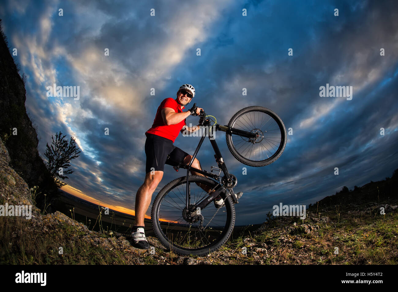 Wide angle view of a cyclist riding a bike on a nature trail in the ...