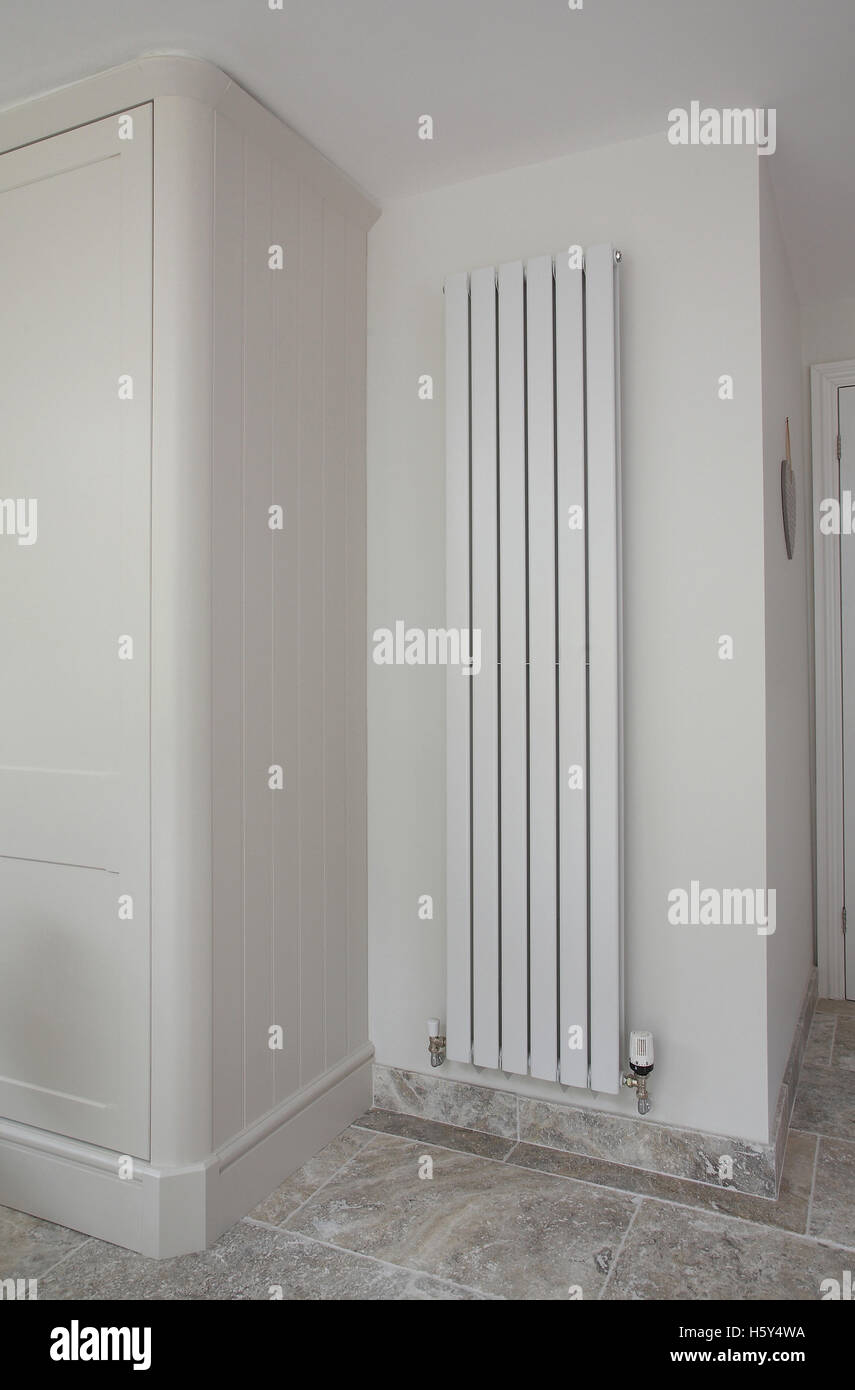 A modern radiator in a white kitchen in the UK Stock Photo - Alamy