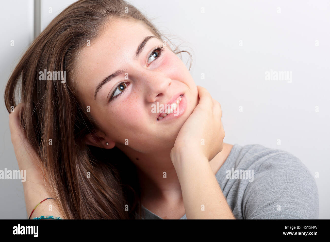 Portrait of adolescent touching the hair. Study on white light Stock ...