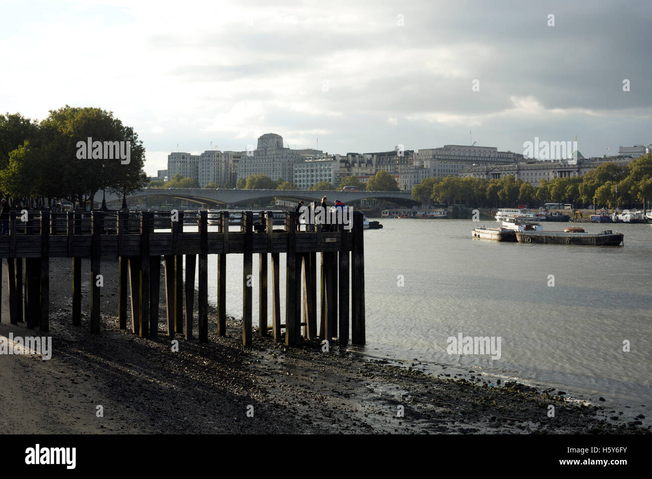 A jetty on the River Thames and view across to Victoria Embankment ...