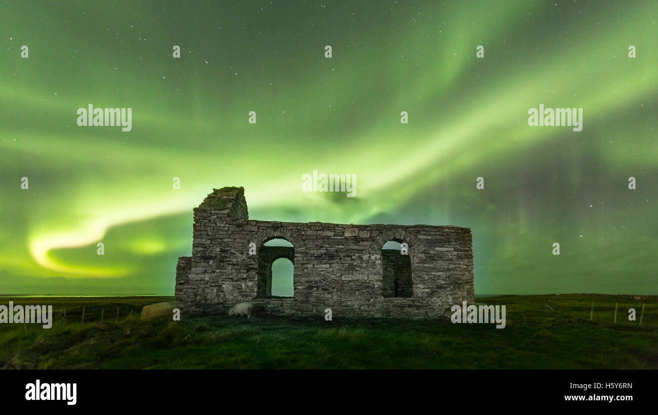 A stunning northern light above an old church ruin Stock Photo - Alamy