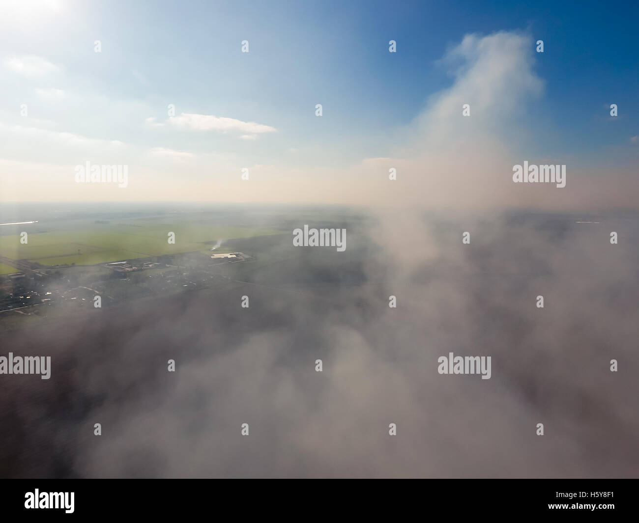 The smoke over the village. Clubs of smoke over the village houses and ...