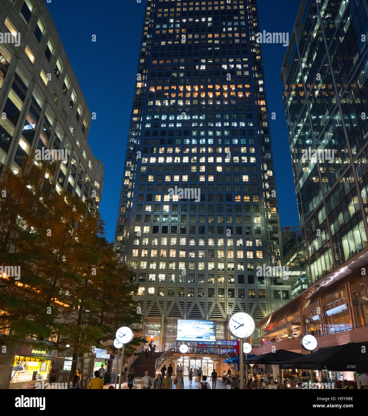 Reuters Square and One Canada at Canary Wharf by night Stock Photo - Alamy