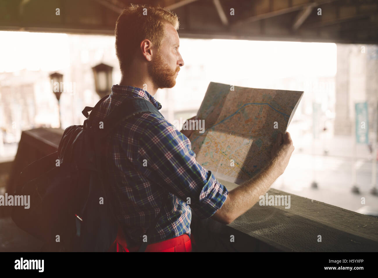 Tourist backpacker using map to travel to destinations Stock Photo - Alamy