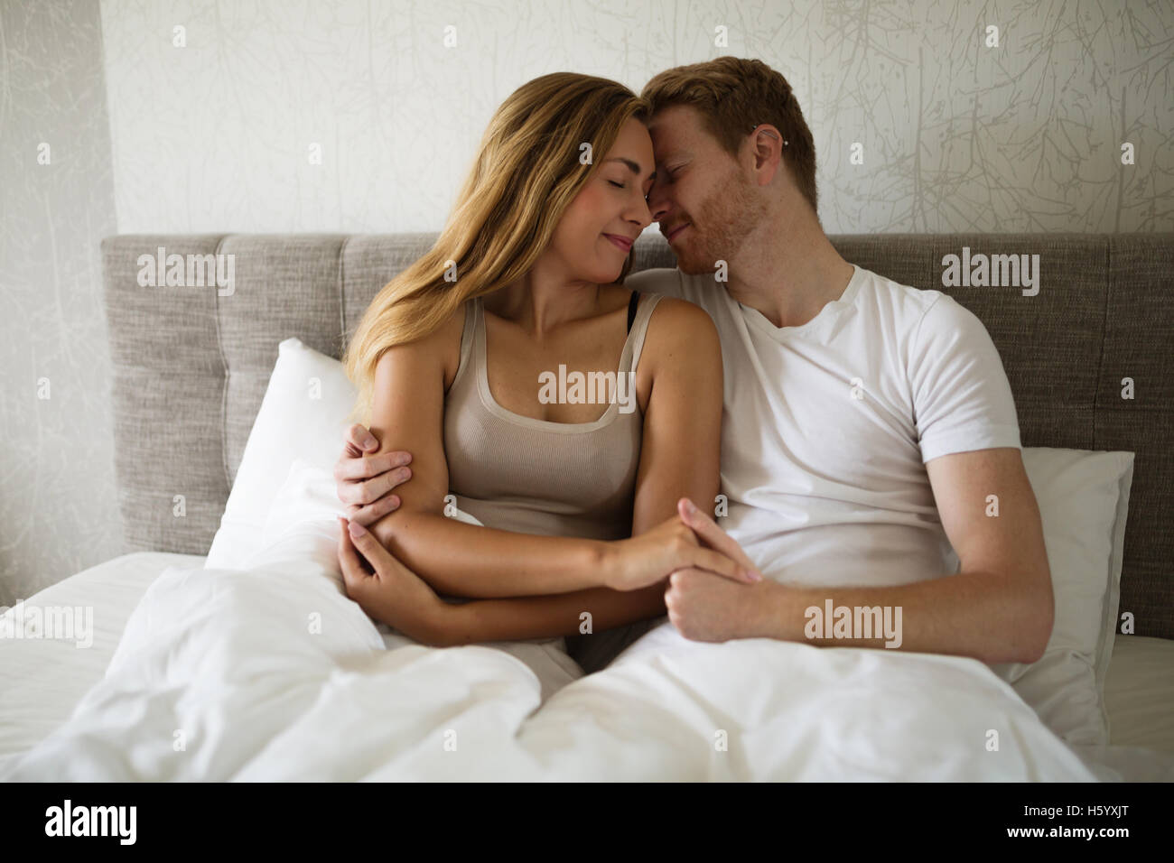 Couple hugging in bed hi-res stock photography and images - Alamy
