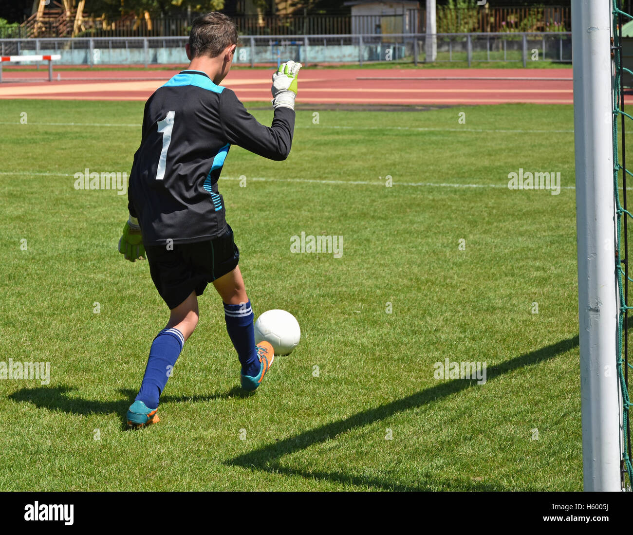Young goalkeeper with a ball at the match Stock Photo - Alamy