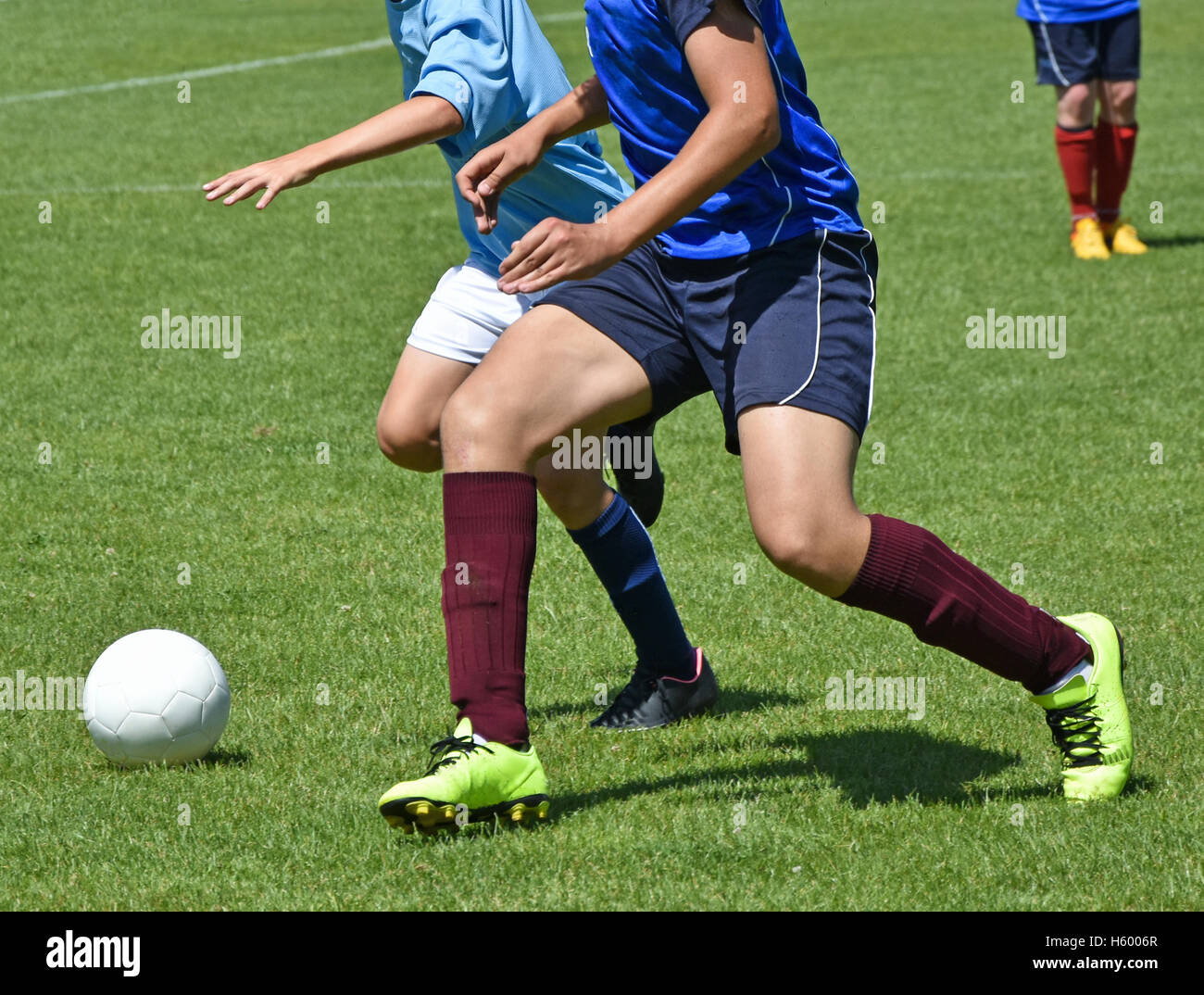 Young soccer players in action outdoors Stock Photo - Alamy