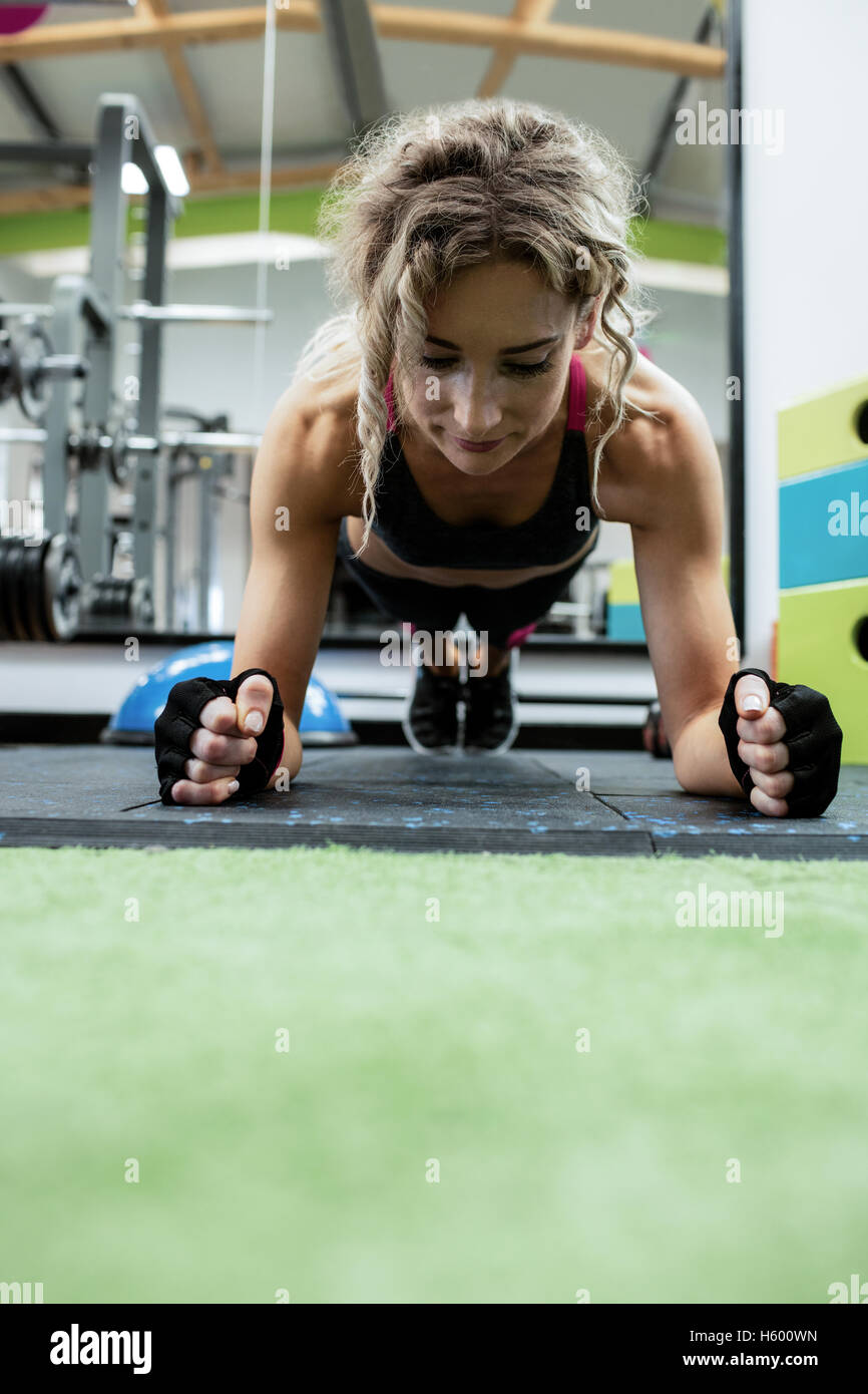 Woman performing push-up exercise Stock Photo - Alamy