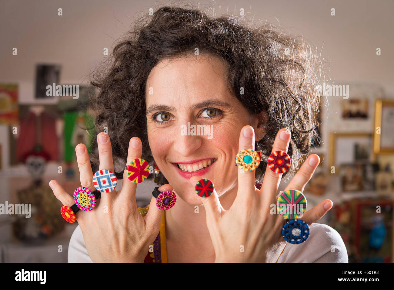 Button maker, young woman with her fingers displaying selection of ten ...