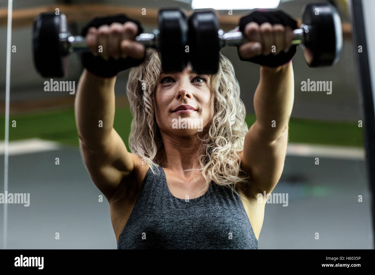 Beautiful woman lifting dumbbells Stock Photo - Alamy