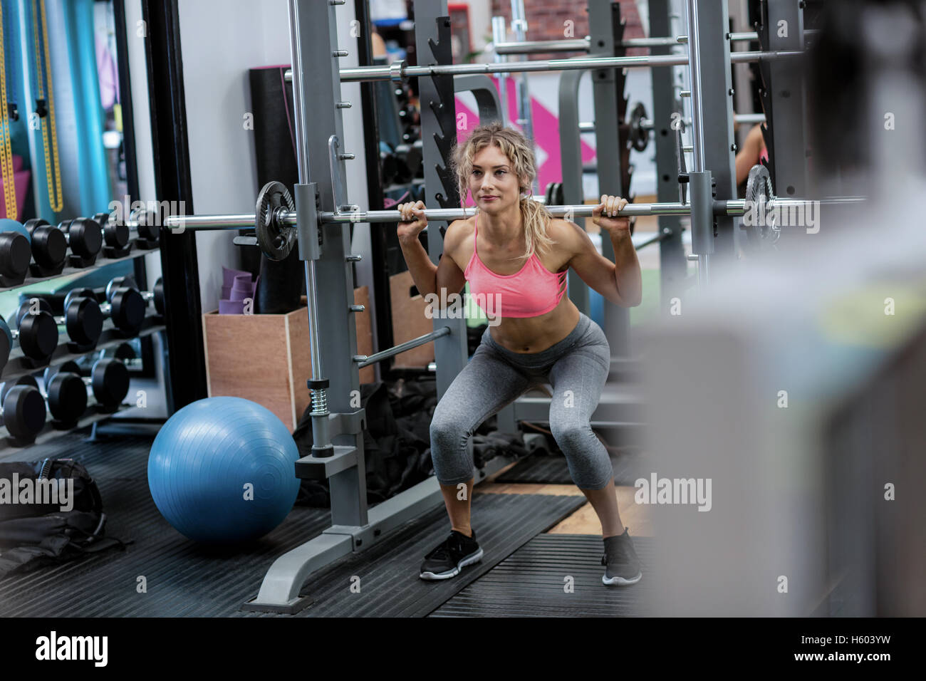 Beautiful woman working out with barbell Stock Photo - Alamy