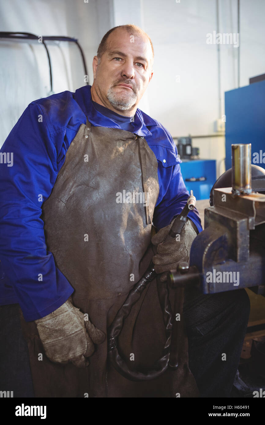Welder holding welding machine in workshop Stock Photo - Alamy