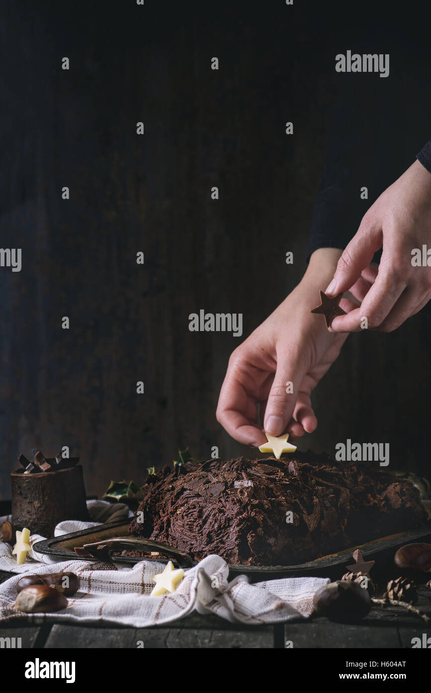Decorating of christmas chocolate yule log Stock Photo - Alamy