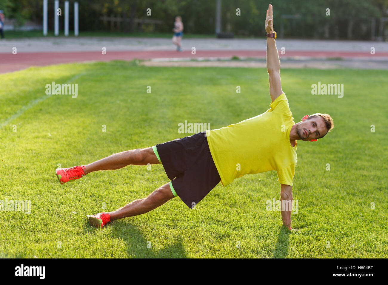 Portrait of athletic caucasian man doing difficult sport exercises on ...