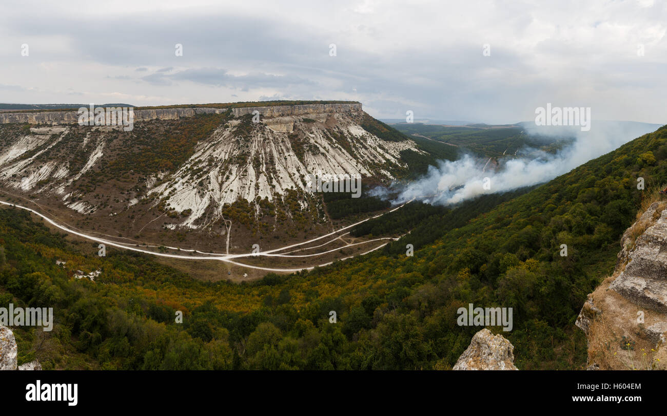 Scenic views of dense forest, rocky hill, and road Stock Photo - Alamy