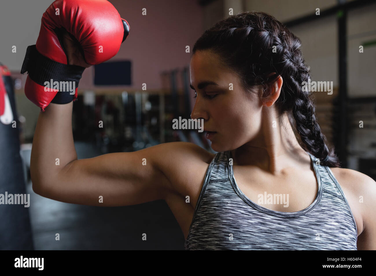 Female boxer in boxing gloves showing muscle Stock Photo - Alamy