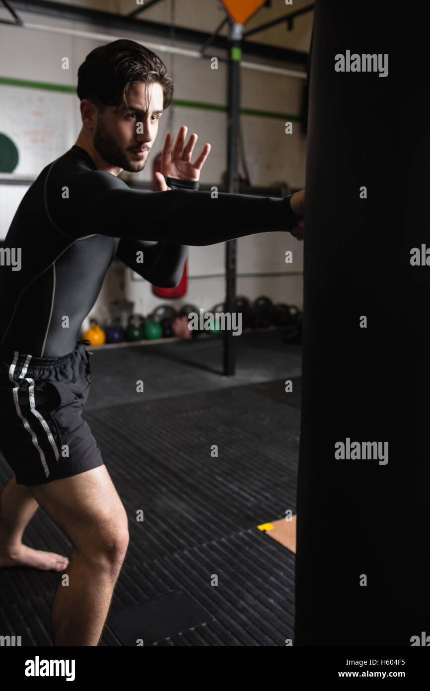 Boxer practicing boxing with punching bag Stock Photo - Alamy