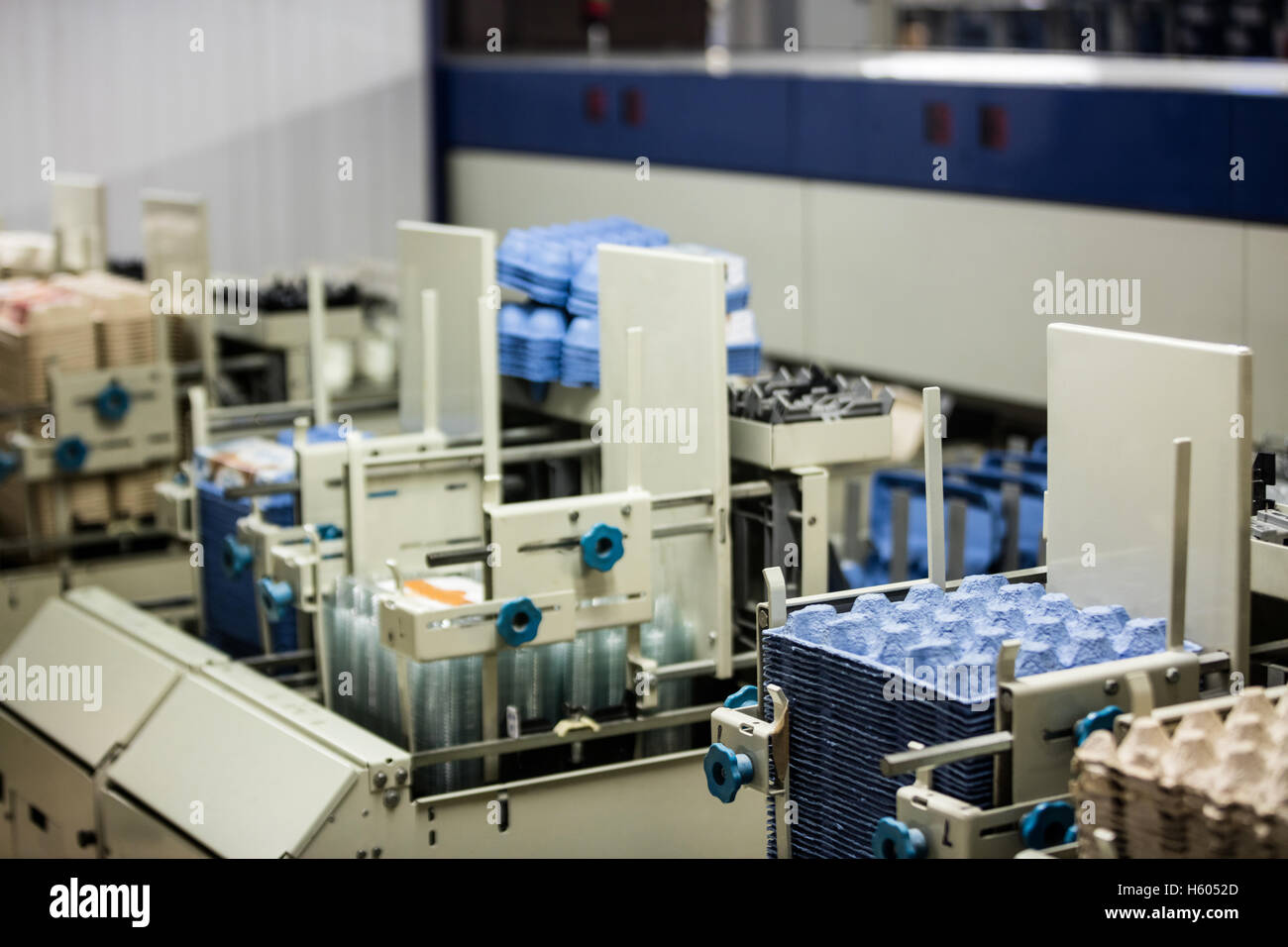 Machinery with egg cartons Stock Photo - Alamy