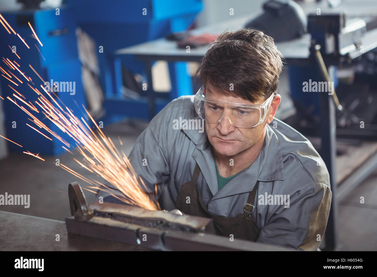 Welder working at work shop Stock Photo - Alamy