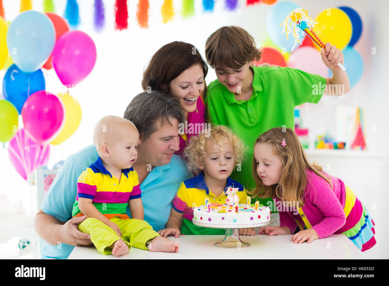 Family celebrating kids birthday. Parents and children celebrate ...