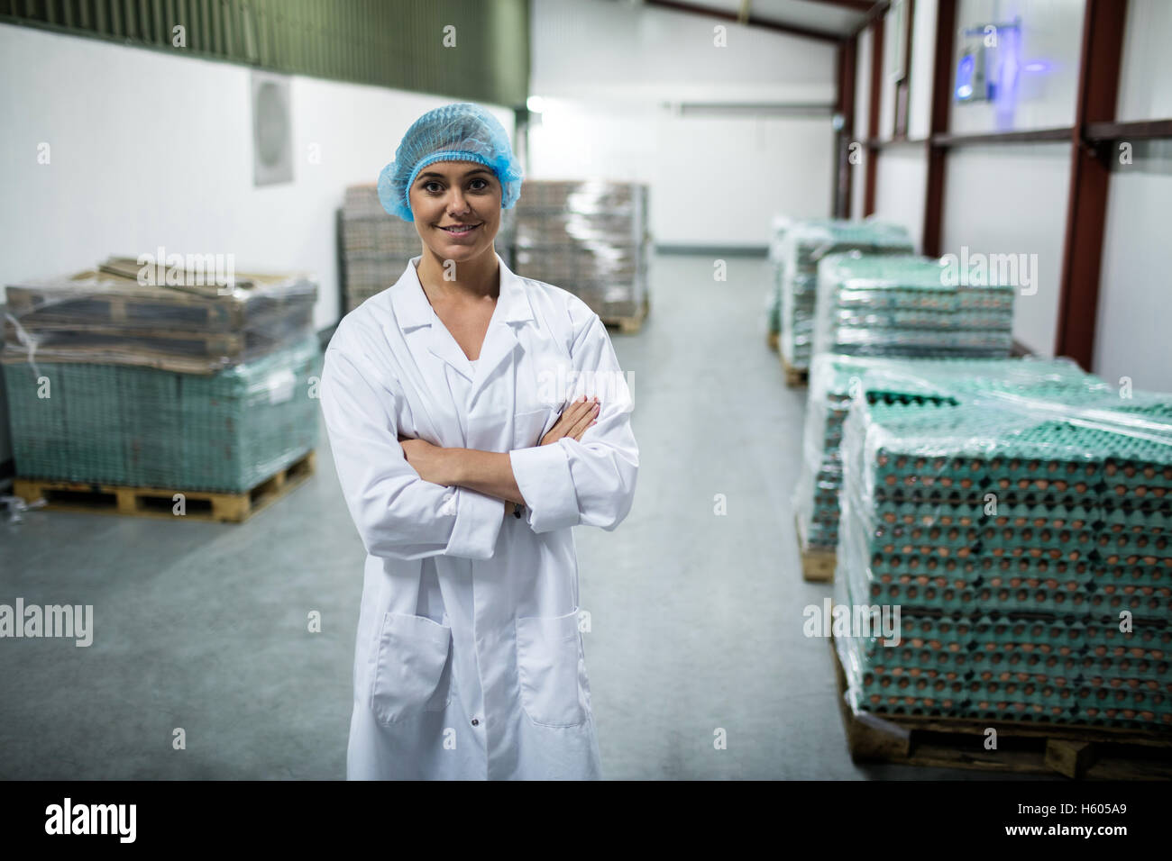 Portrait of female staff standing in egg factory Stock Photo - Alamy