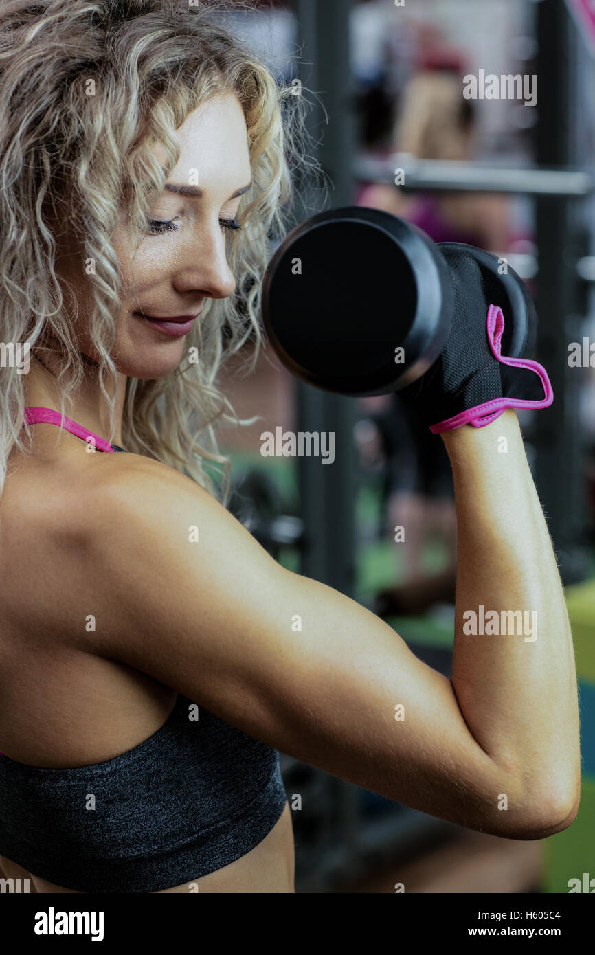 Beautiful woman lifting dumbbell Stock Photo - Alamy