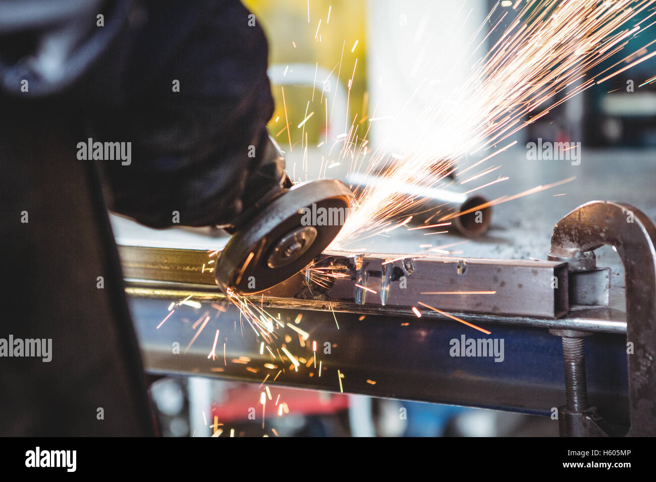 Welder cutting metal with electric tool in workshop Stock Photo - Alamy
