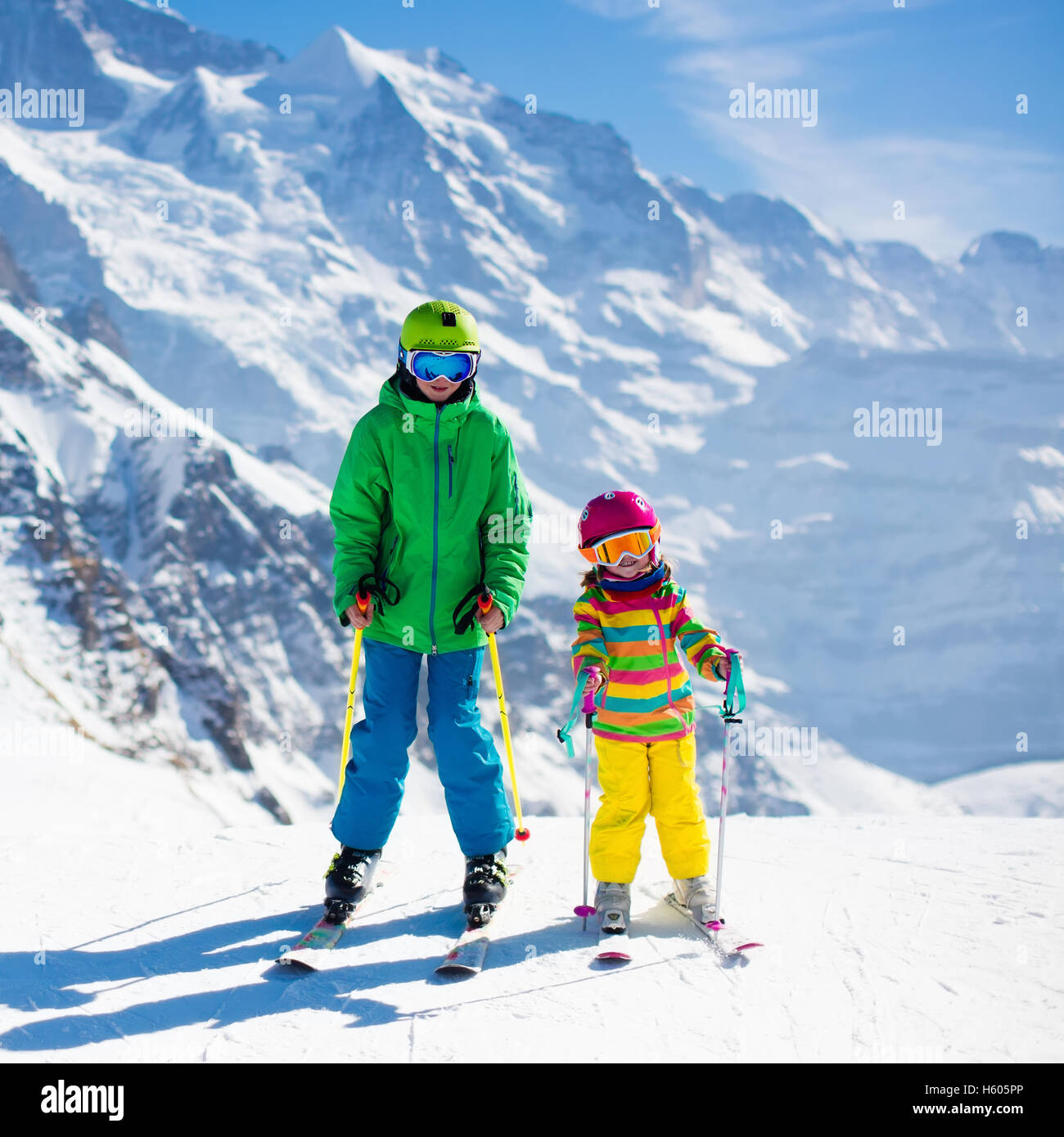 Kids skiing in mountains. Active children with safety helmet, goggles ...