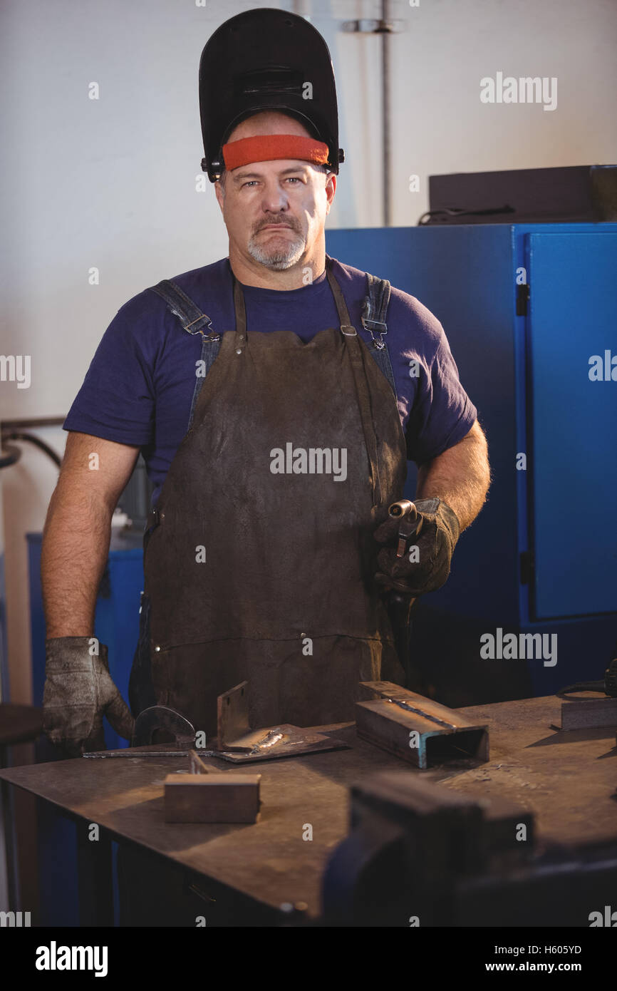 Portrait of welder standing in workshop Stock Photo - Alamy