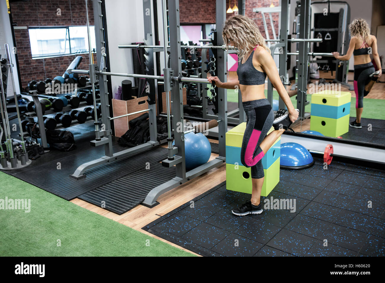 Woman performing exercise Stock Photo - Alamy