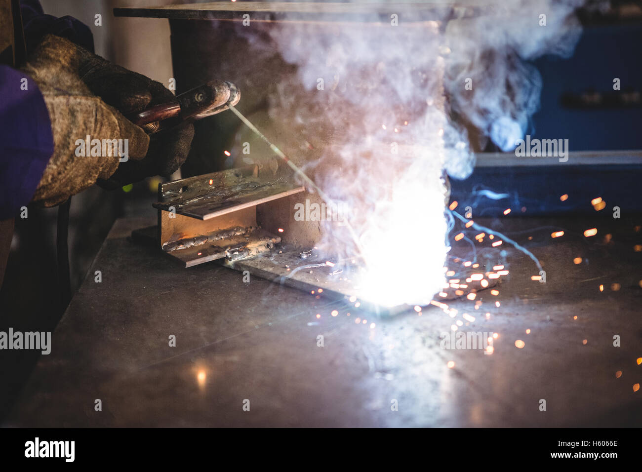 Welder welding a metal in workshop Stock Photo - Alamy