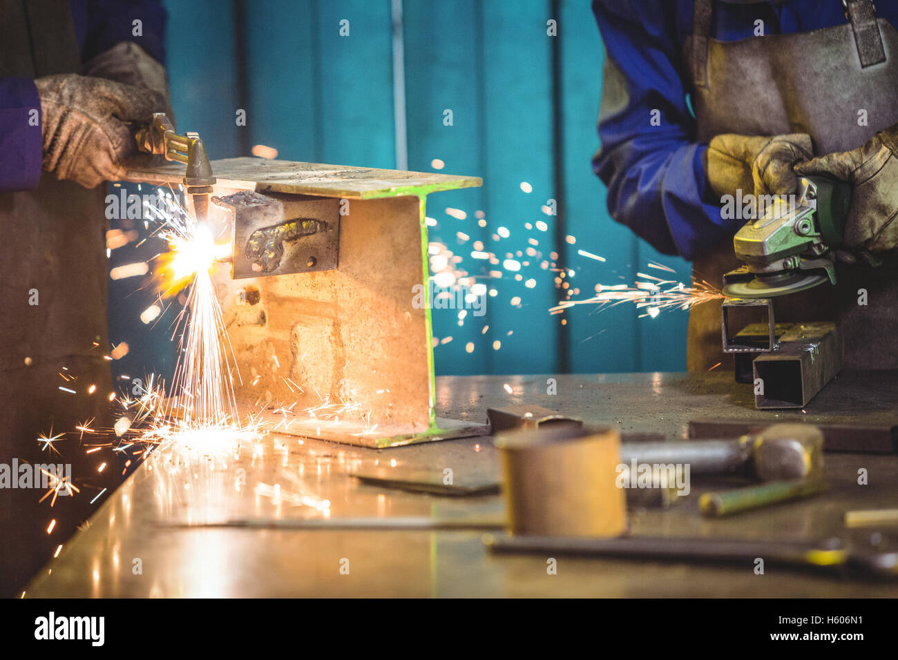 Mid-section of welders working at work shop Stock Photo - Alamy