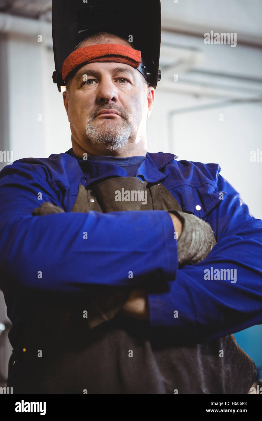 Welder standing with arm crossed in workshop Stock Photo - Alamy