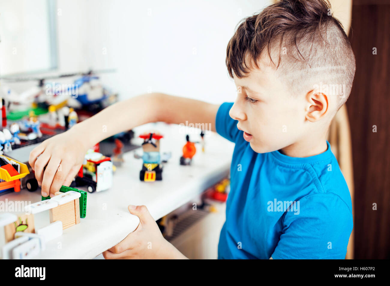 little cute preschooler boy playing lego toys at home happy smiling ...