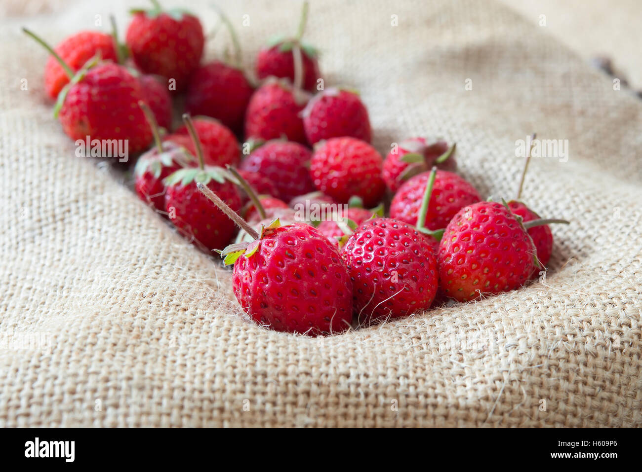 strawberry on sack backgrounds Stock Photo - Alamy