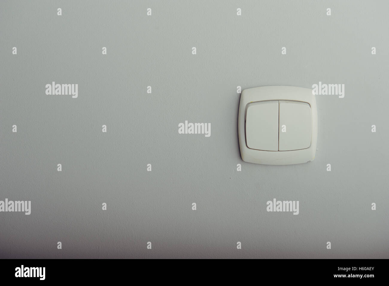 White plastic light switch on a gray wall Stock Photo - Alamy