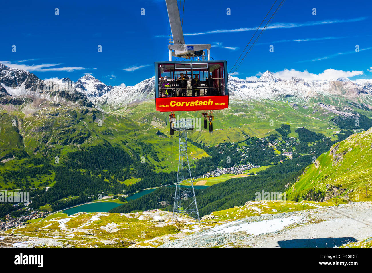 People in Corvatsch cable car enjoying the stunning view of lake Sils ...