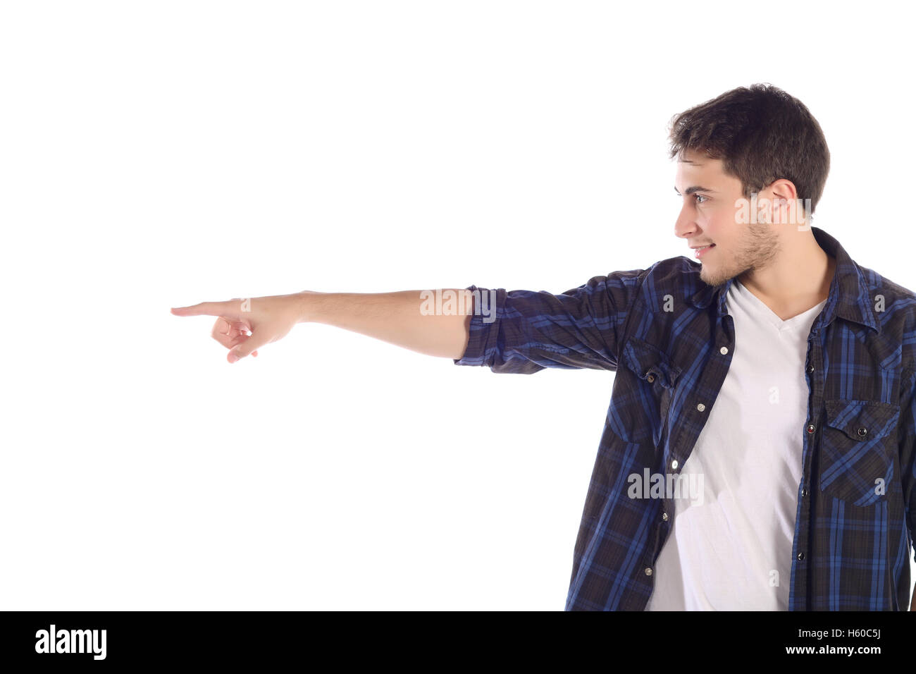 Portrait of a young handsome man pointing at something. Isolated white ...