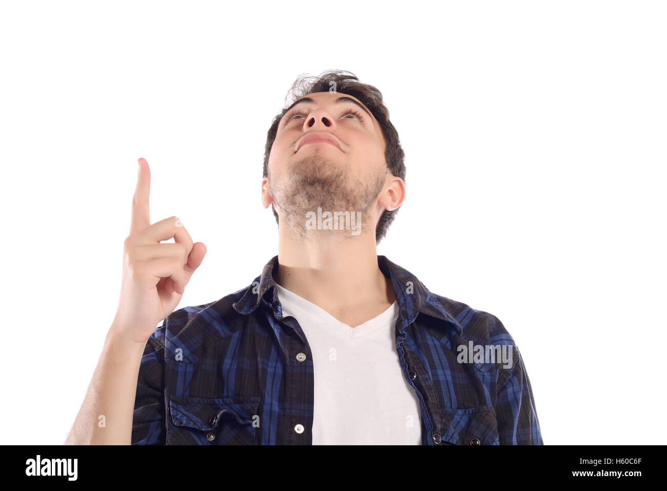 Portrait of a young handsome man pointing up. Isolated white background ...