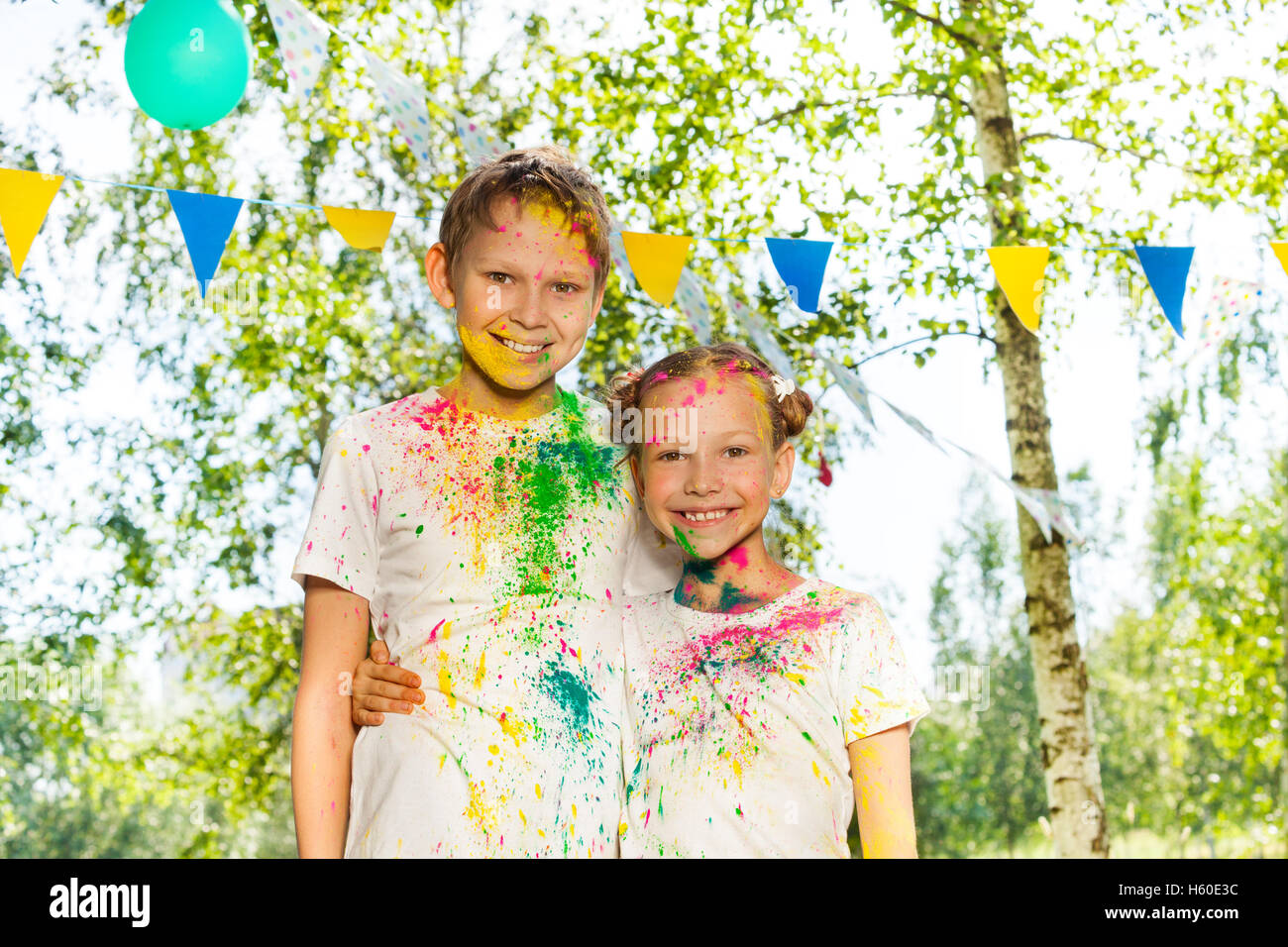 Portrait of happy kids smeared with colored powder Stock Photo - Alamy