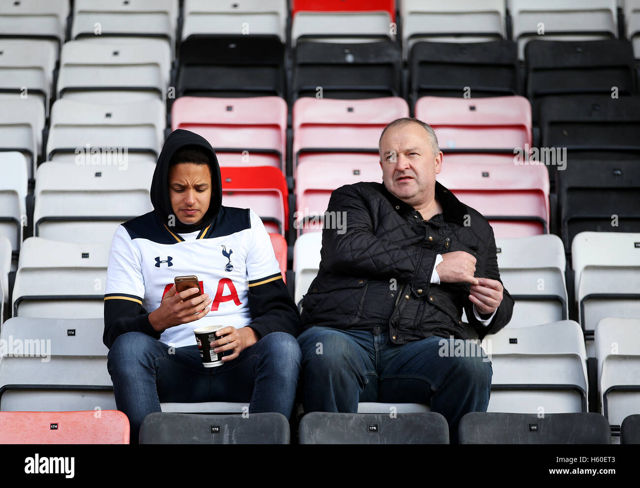 Two Tottenham Hotspur fans take their seats in the stands before the ...