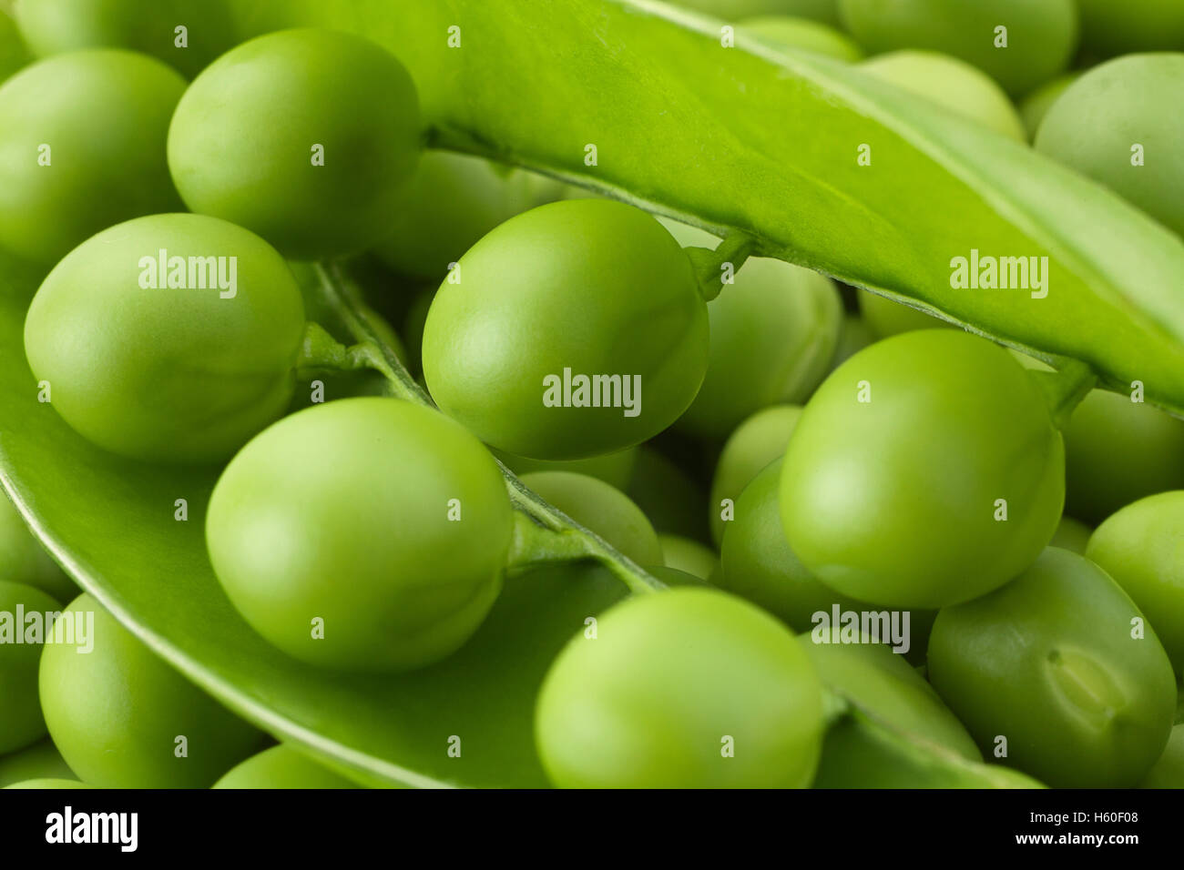 Young grean peas closeup view background Stock Photo - Alamy