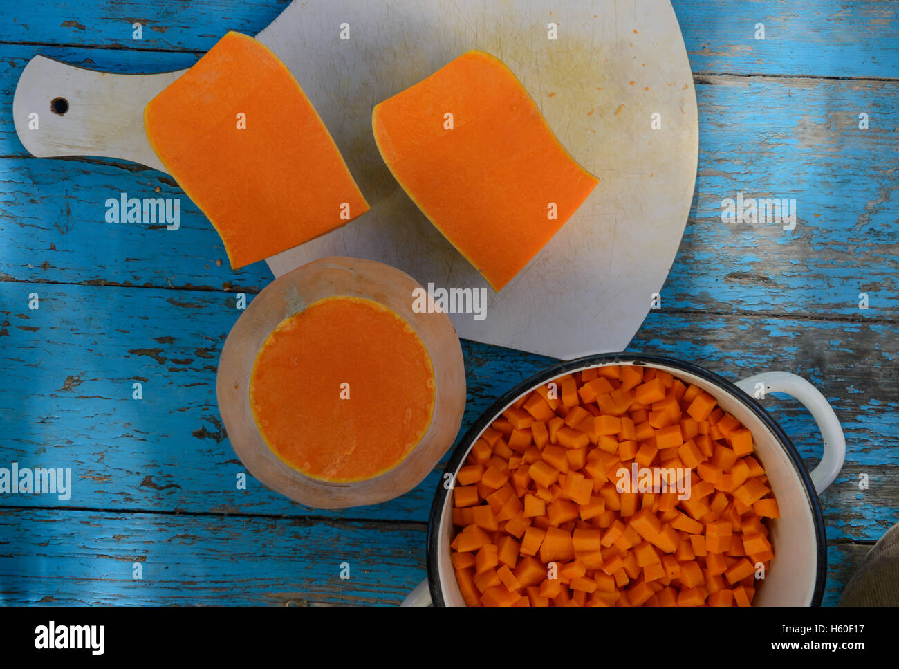 Cutted into sections and pieces of bright orange color pumpkin is on ...