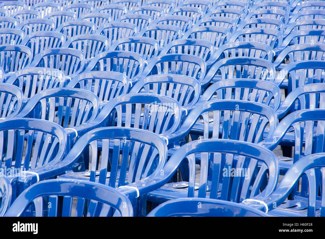 Many rows with a lot of blue pastic chairs Stock Photo - Alamy