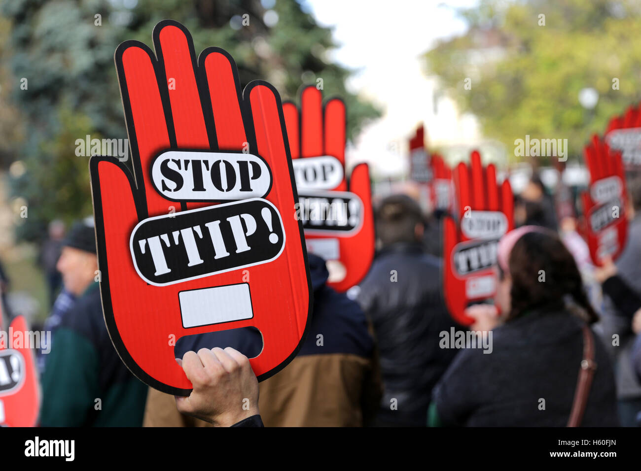 Activists are holding red hand signs "Stop TTIP" during a demonstration ...