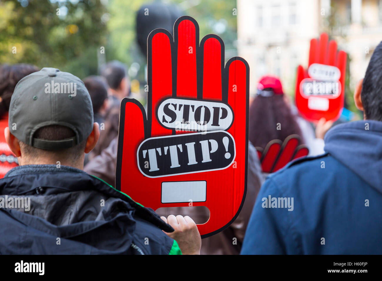 Activists are holding red hand signs "Stop TTIP" during a demonstration ...