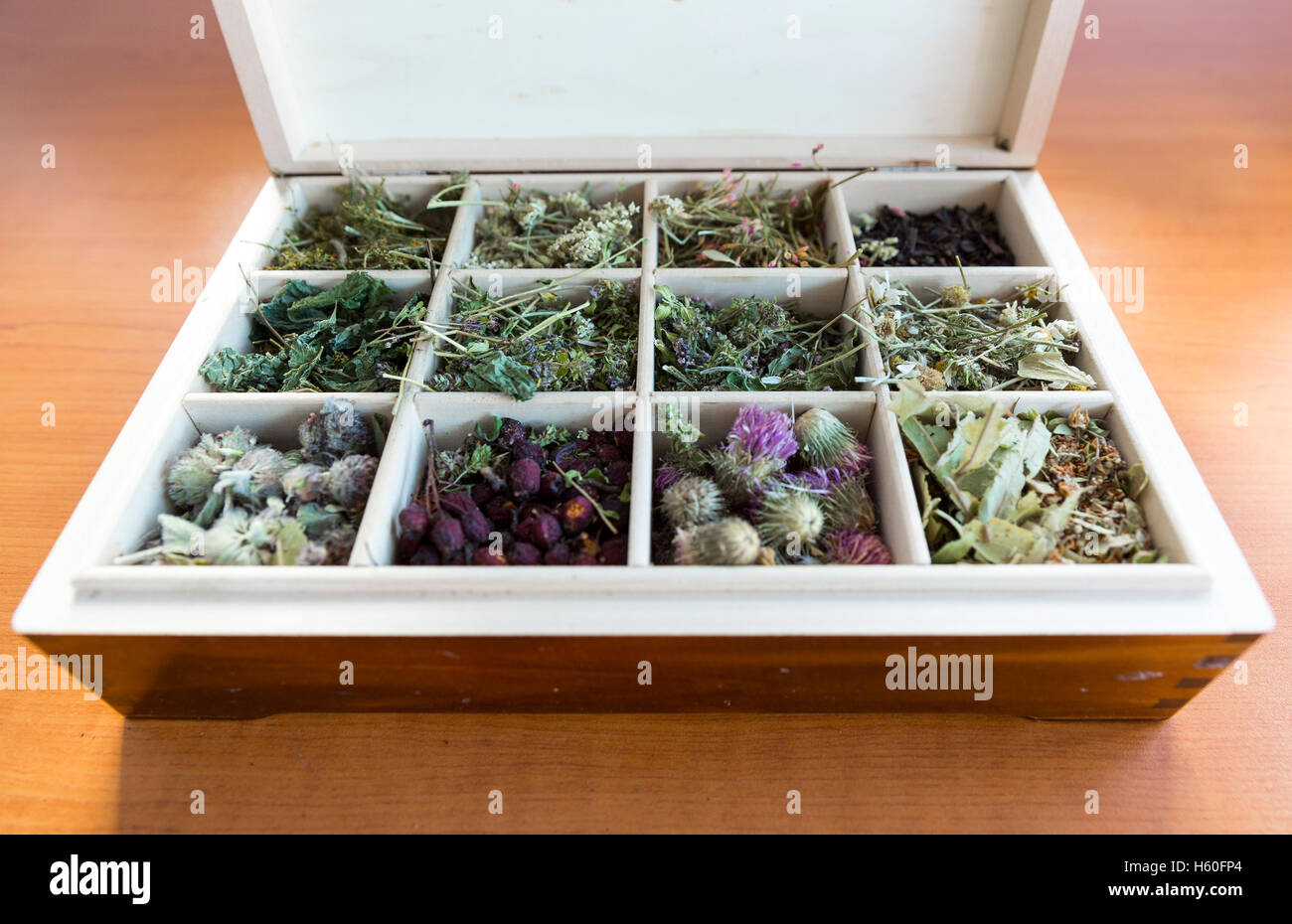 Different dried herbs in a wooden tea box Stock Photo - Alamy