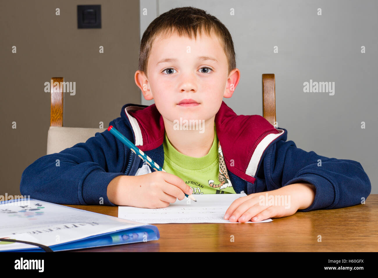 Boy doing homework in a living room Stock Photo - Alamy