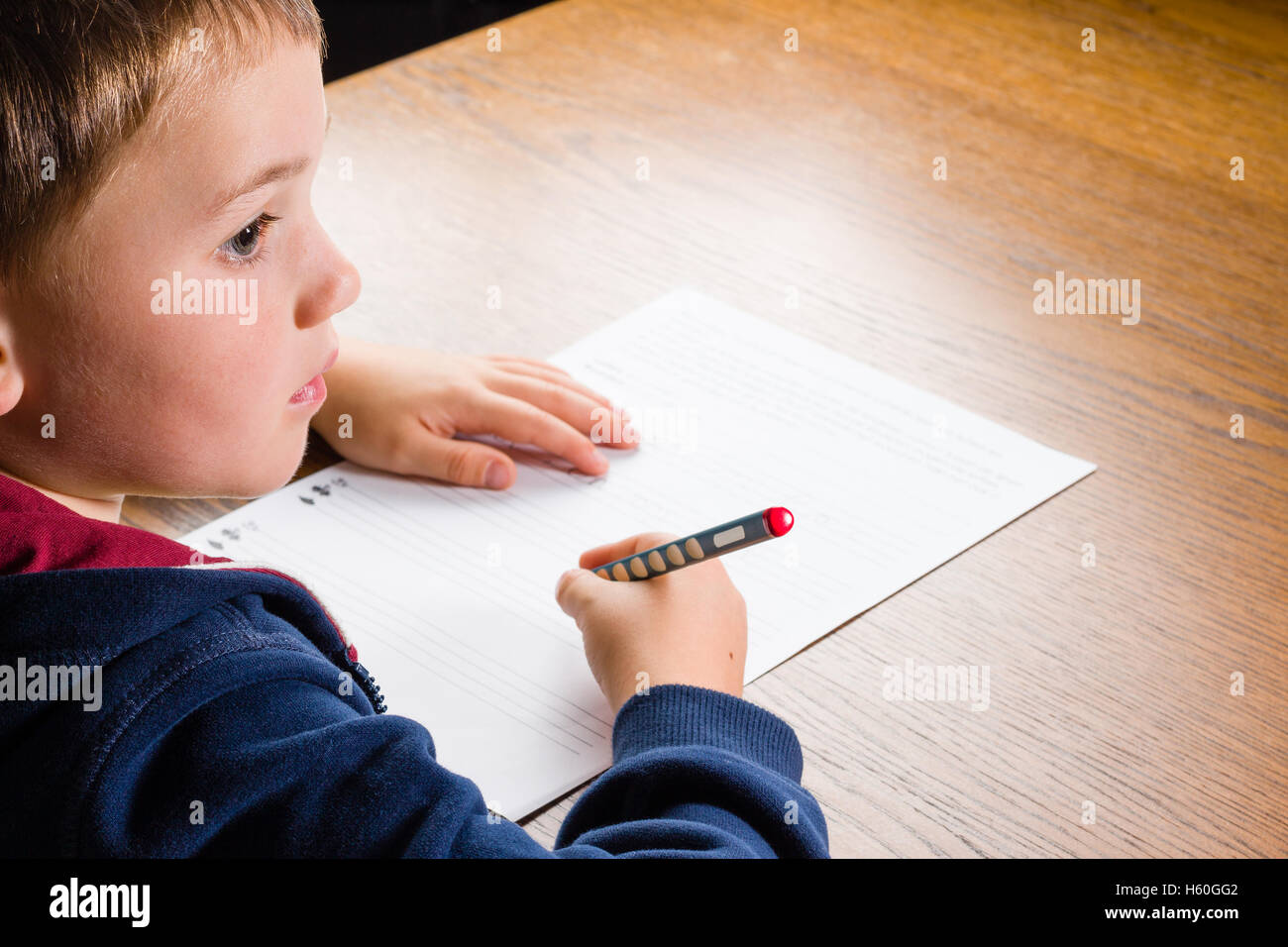 Boy doing homework Stock Photo - Alamy