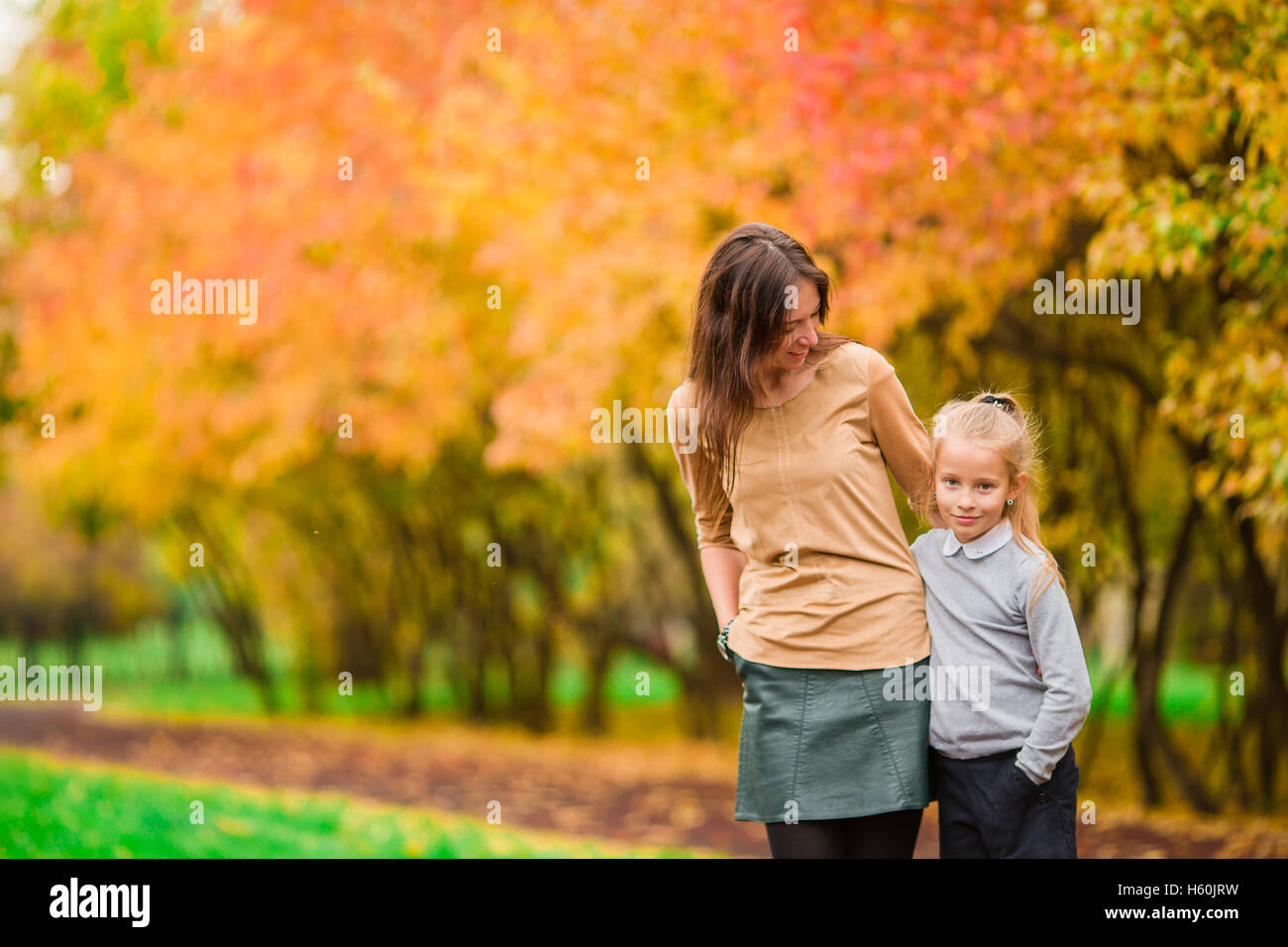 Family in fall. Mother and kid enjoy warm autumn Stock Photo - Alamy